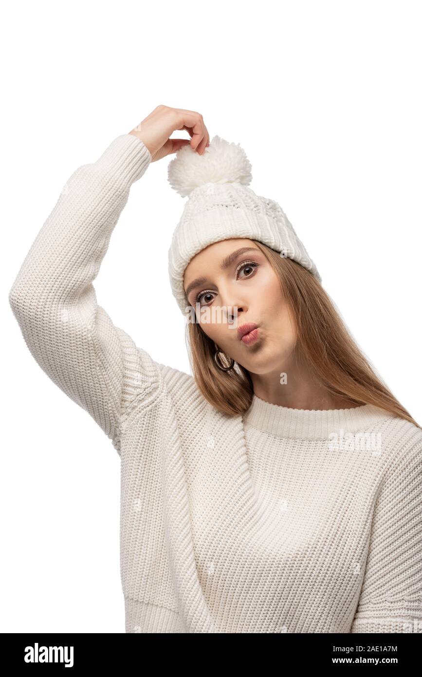 attractive funny woman making grimace in white knitted sweater and hat ...
