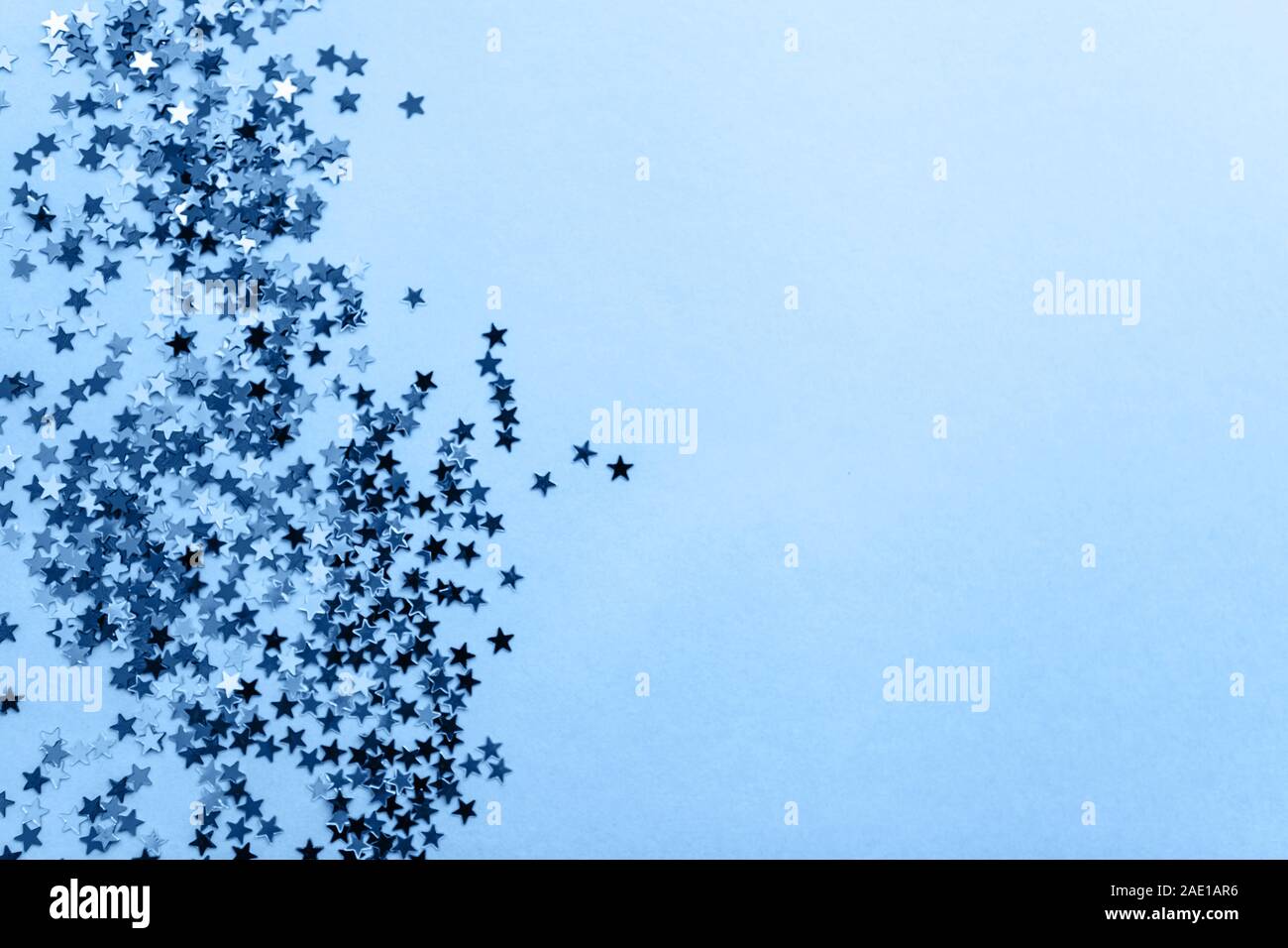 Festive in classic blue color stars of confetti Stock Photo - Alamy