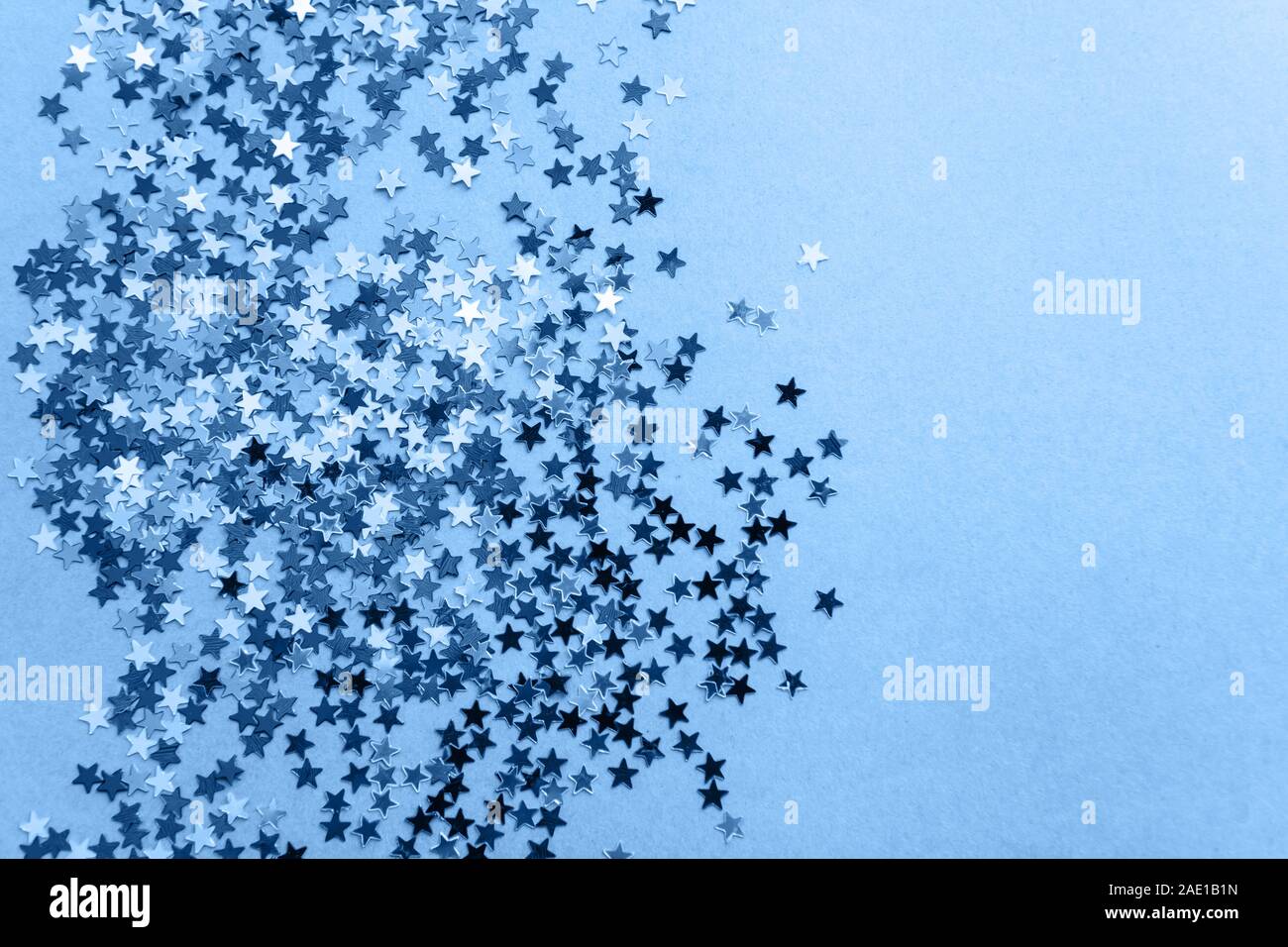 Festive in classic blue color stars of confetti Stock Photo - Alamy