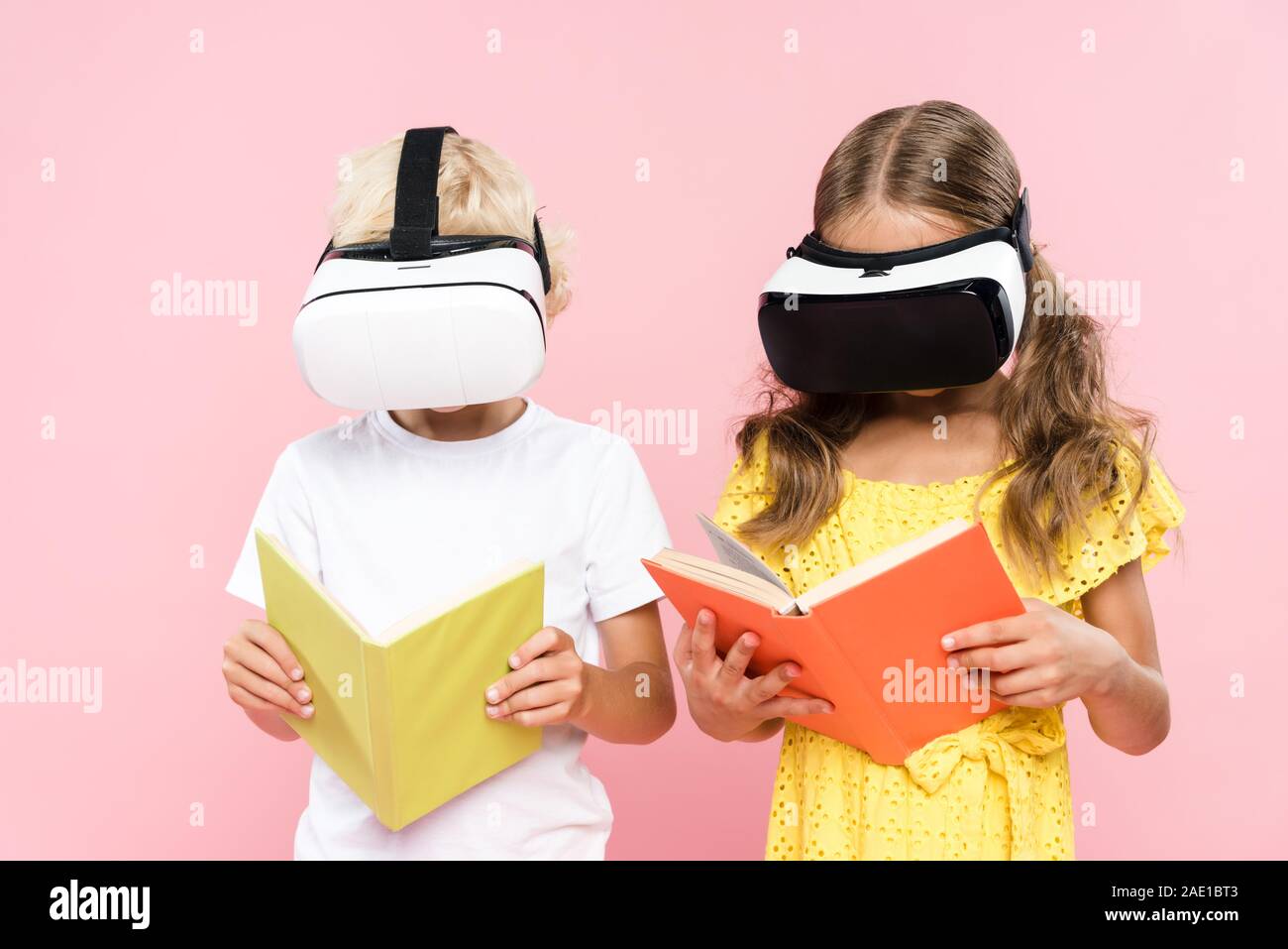 kids with virtual reality headset reading book isolated on pink Stock ...