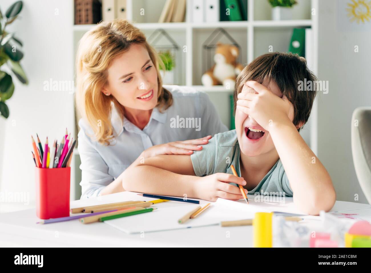 upset kid with dyslexia obscuring face and crying, smiling child ...
