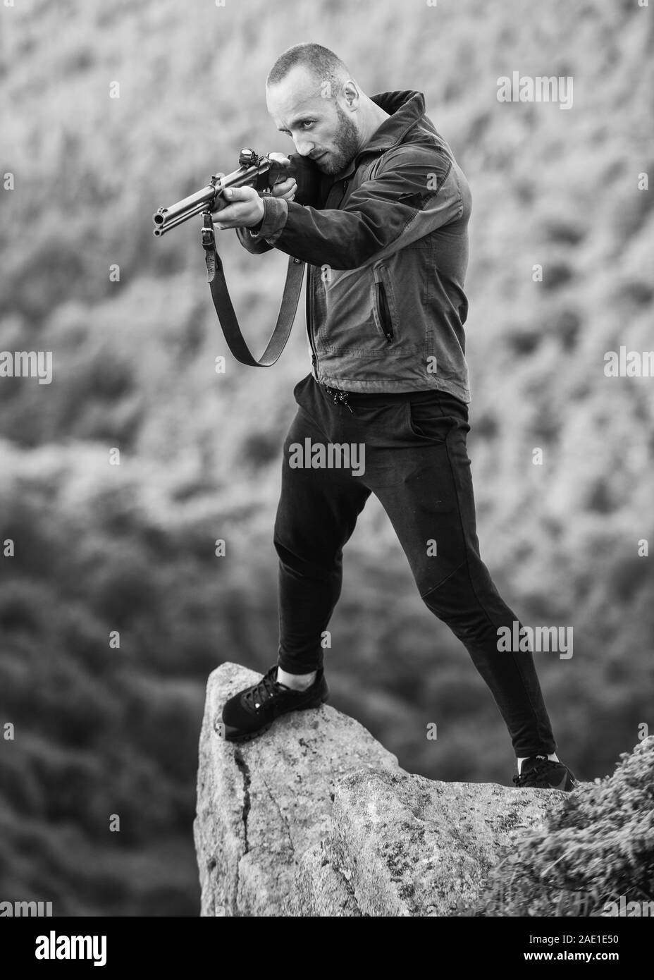 Poaching concept. Poacher stand on edge of cliff. Hunter poacher ...