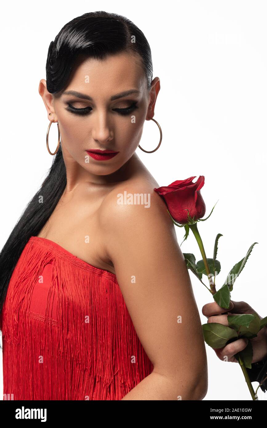 beautiful, elegant dancer looking at red rose in hand of partner while ...