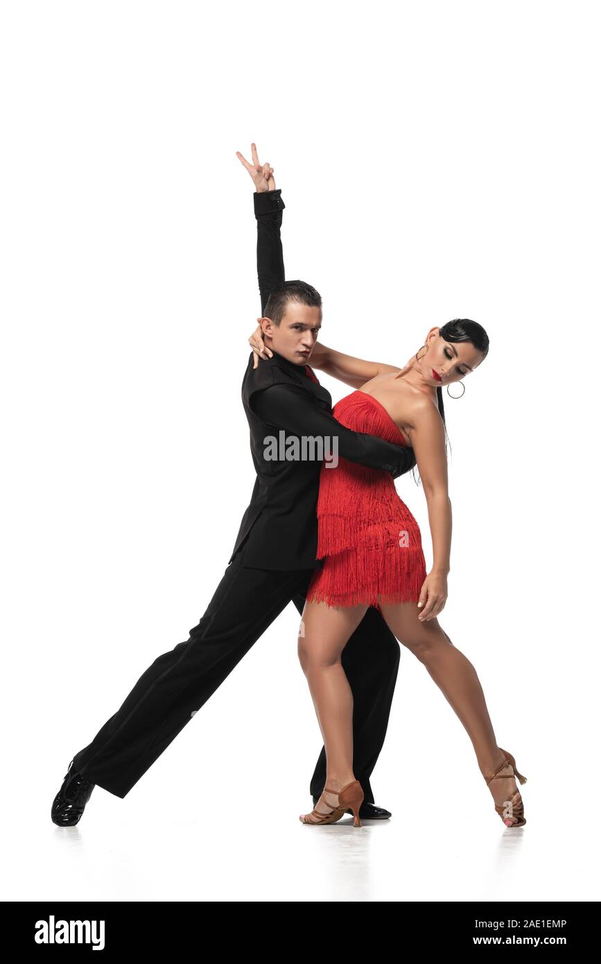 elegant dancer showing victory gesture while performing tango with ...