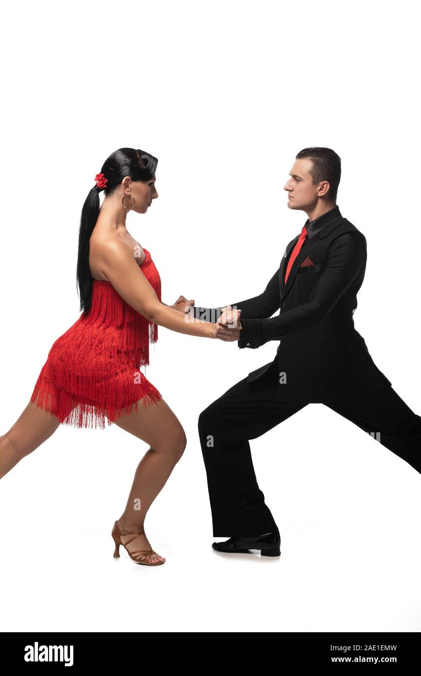 passionate, elegant dancers looking at each other and holding hands ...