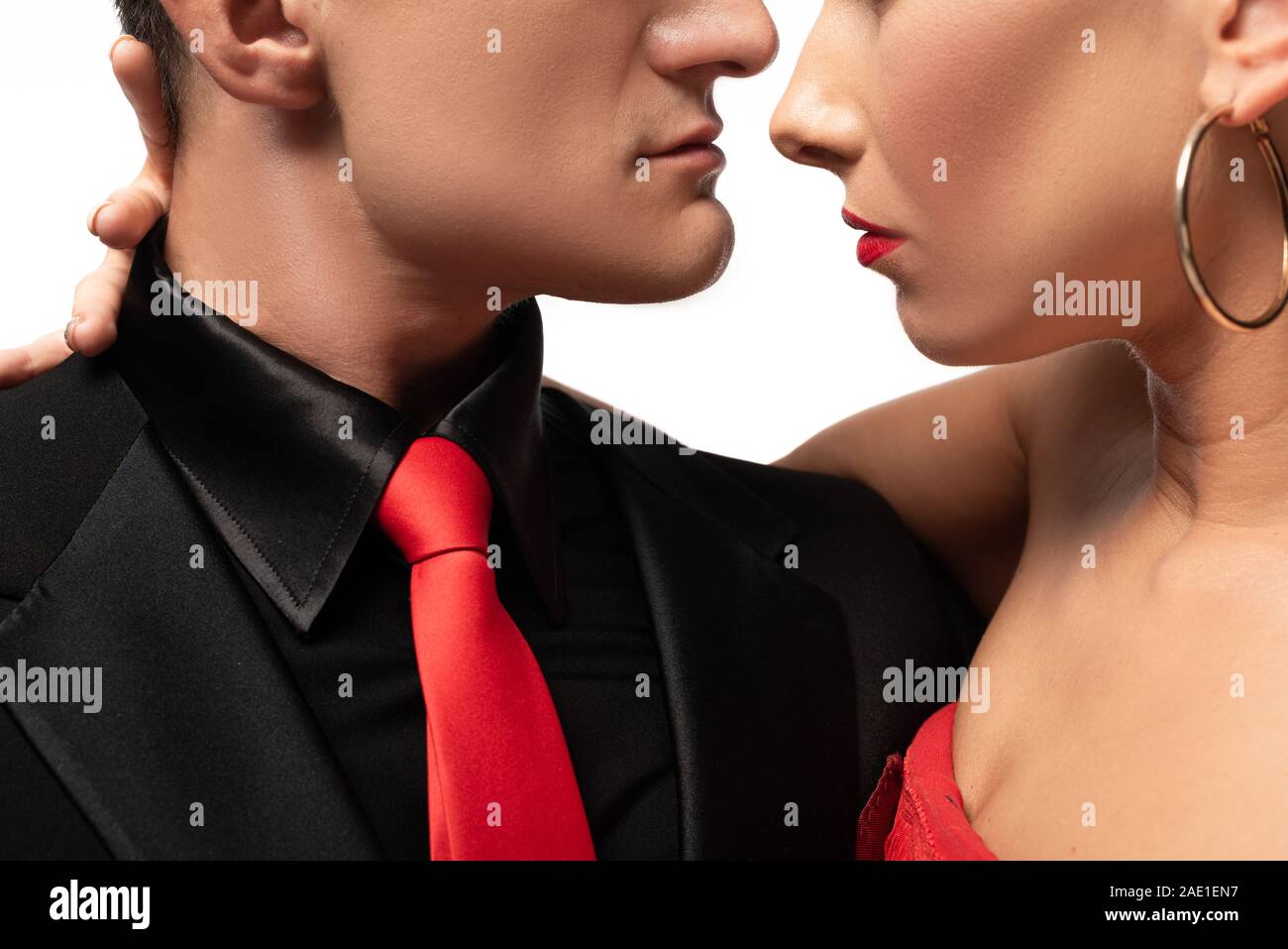 cropped view of sensual dancers performing tango face to face isolated ...