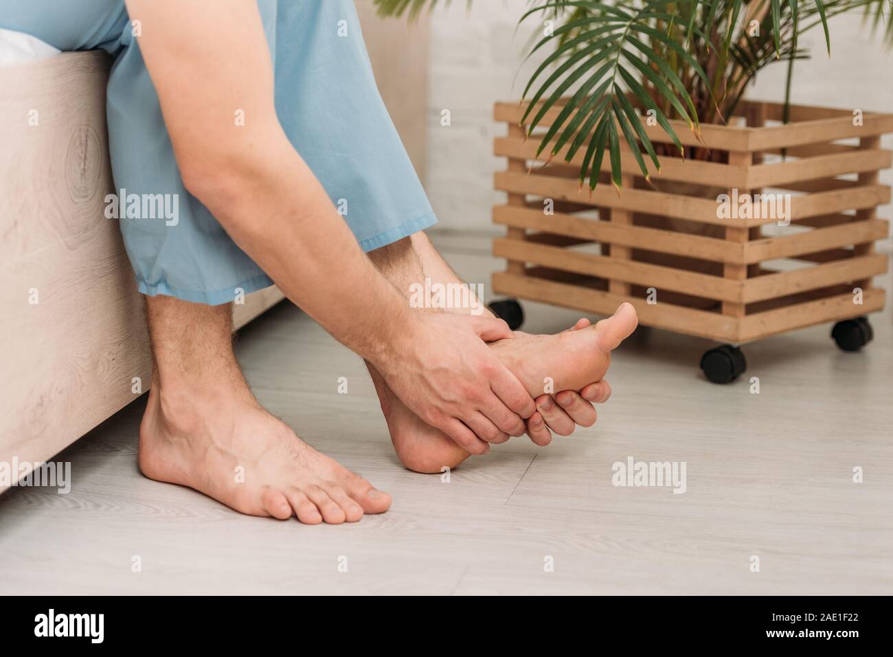 Man touching his foot hi-res stock photography and images - Alamy