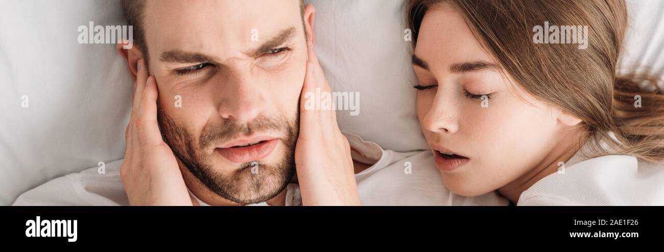 Unhappy man plugging ears hi-res stock photography and images - Alamy