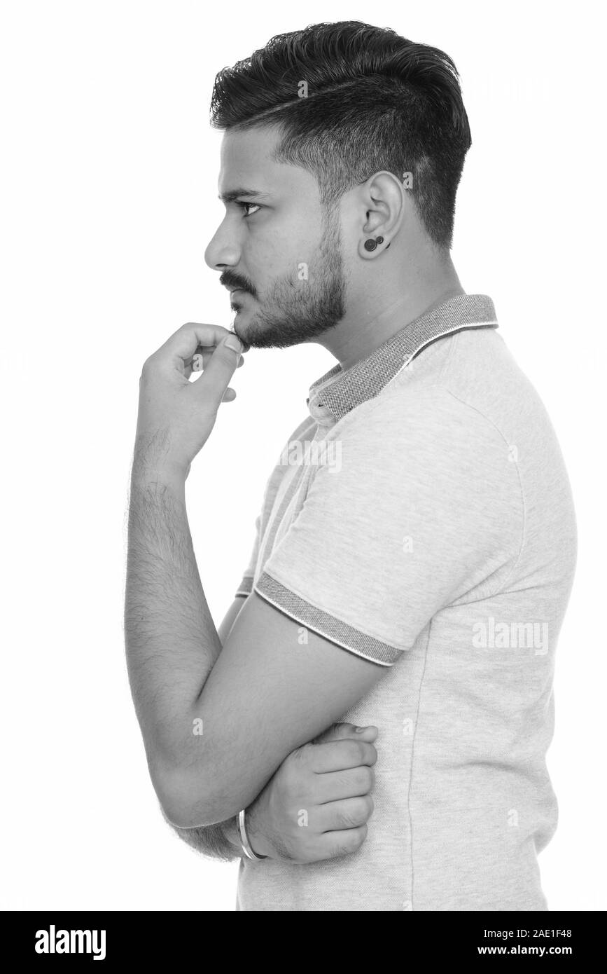 Side view young handsome Indian man thinking Stock Photo - Alamy