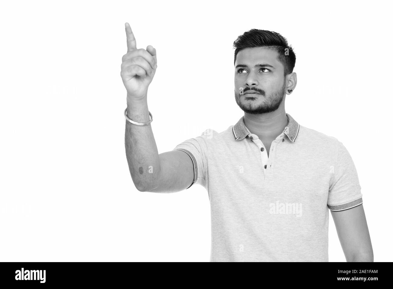 Young handsome Indian man thinking and pointing finger Stock Photo - Alamy