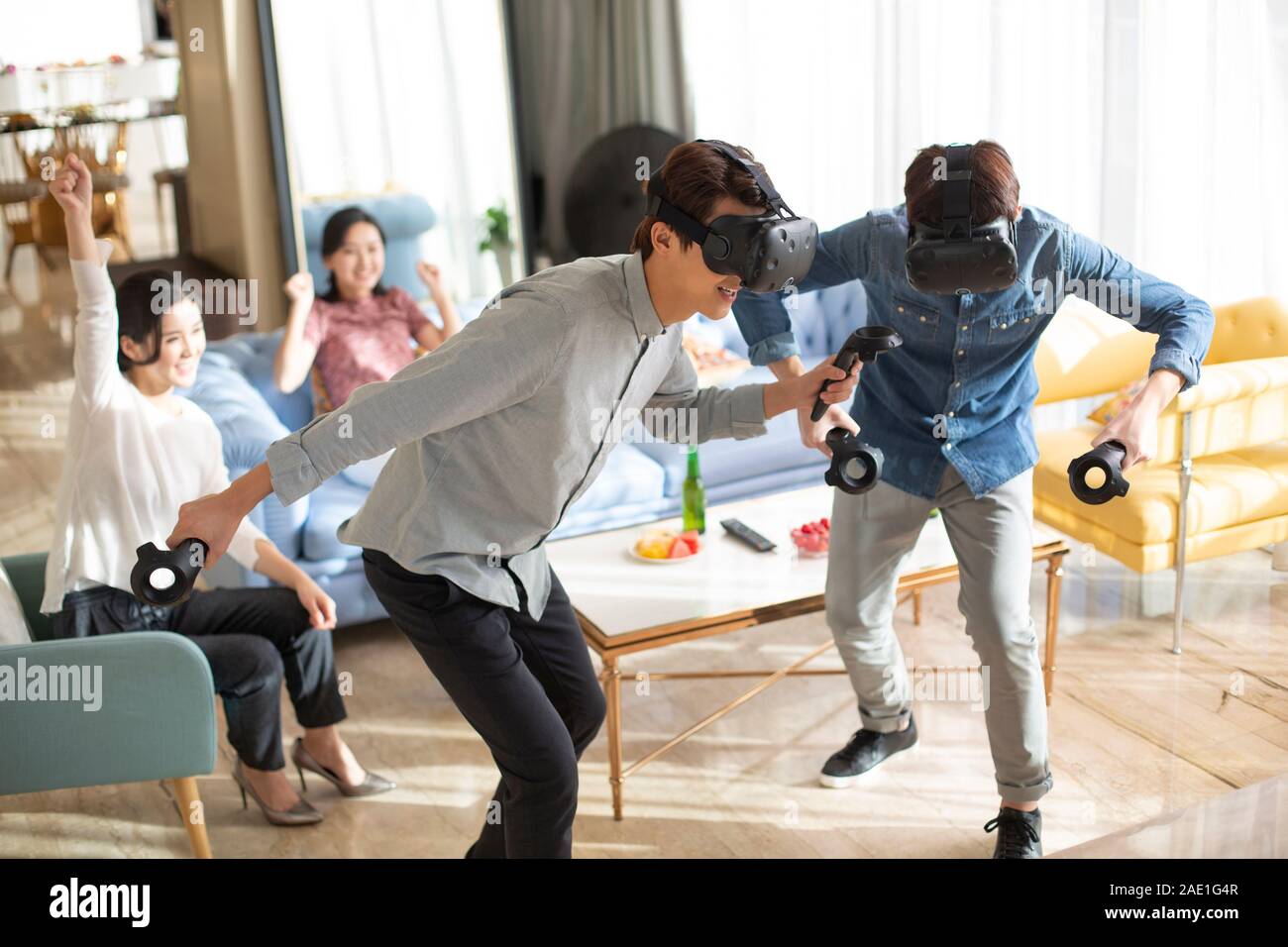 Young friends playing VR game Stock Photo - Alamy