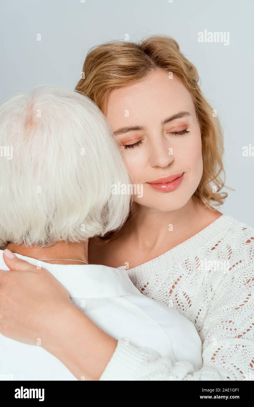 back view of mother hugging smiling daughter isolated on grey Stock ...