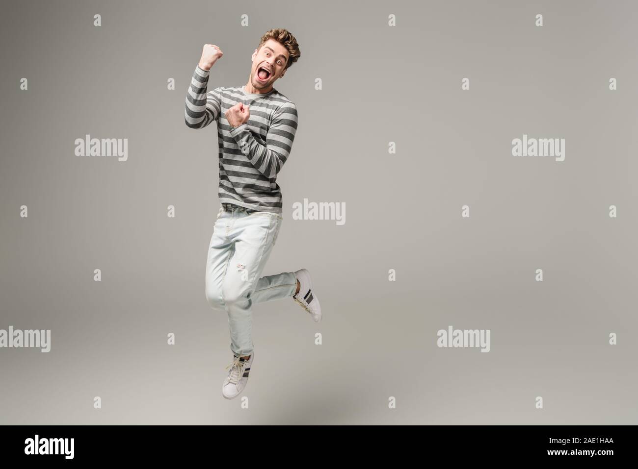 Surprised young man jumping hi-res stock photography and images - Alamy
