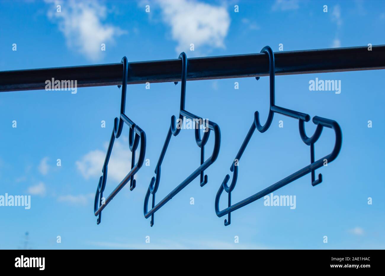 The hanger blue on the rails, stainless steel Stock Photo - Alamy