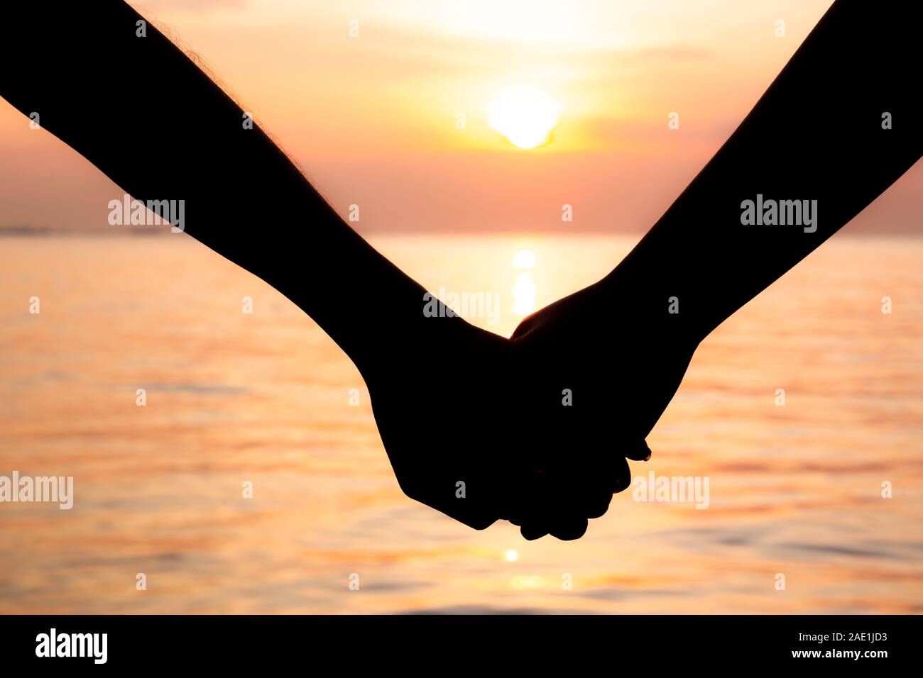 Holding hands watching sunset hi-res stock photography and images - Alamy