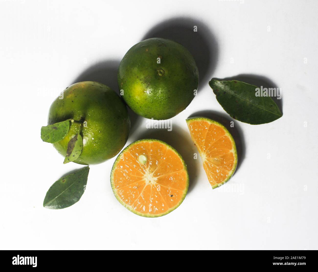 Group of fresh green citrus fruits and their leaves which have orange ...