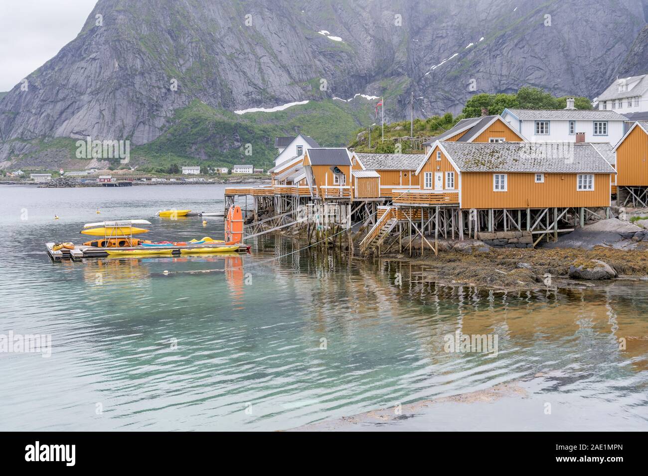 Arctic circle fjord cityscape with traditional stilt rorbuers on shore ...