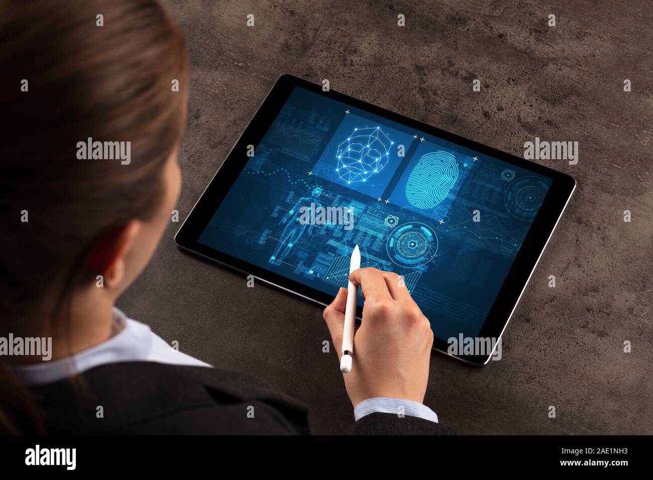 Business woman making analyses and checking fingerprints on tablet ...