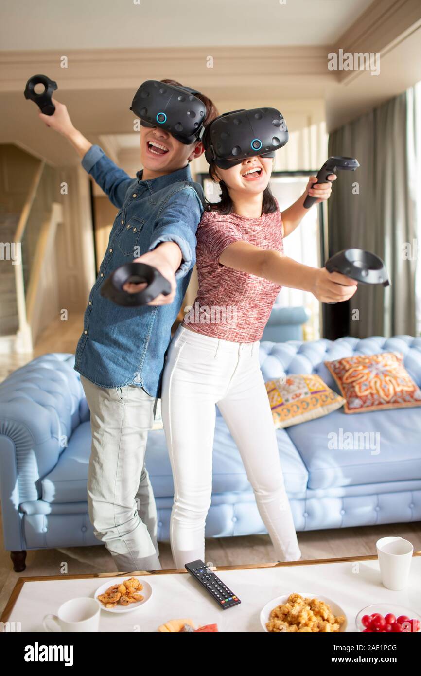 Young couple playing VR game Stock Photo - Alamy