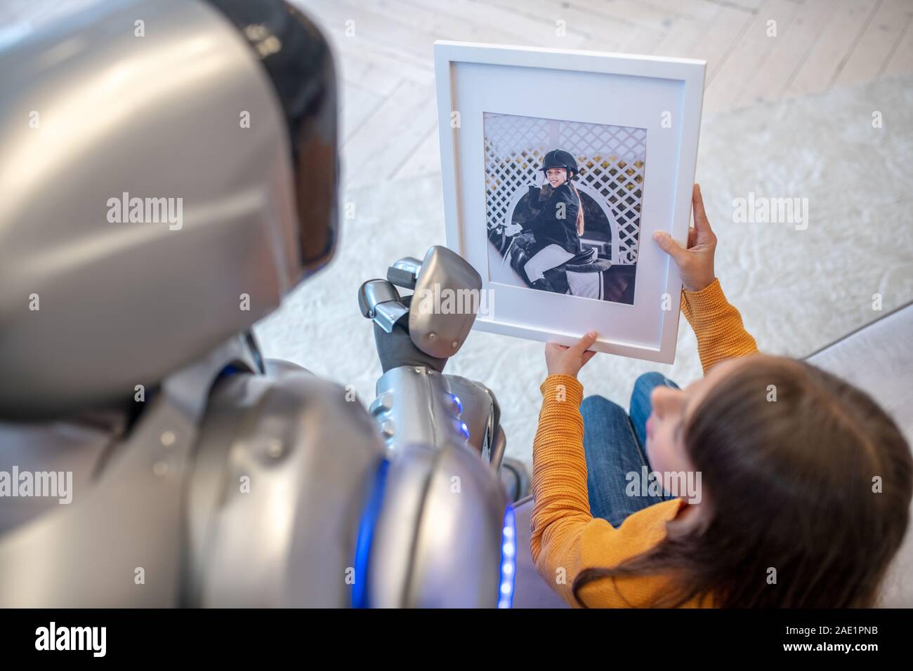 Dark-haired girl holding a portrait in her hands Stock Photo - Alamy