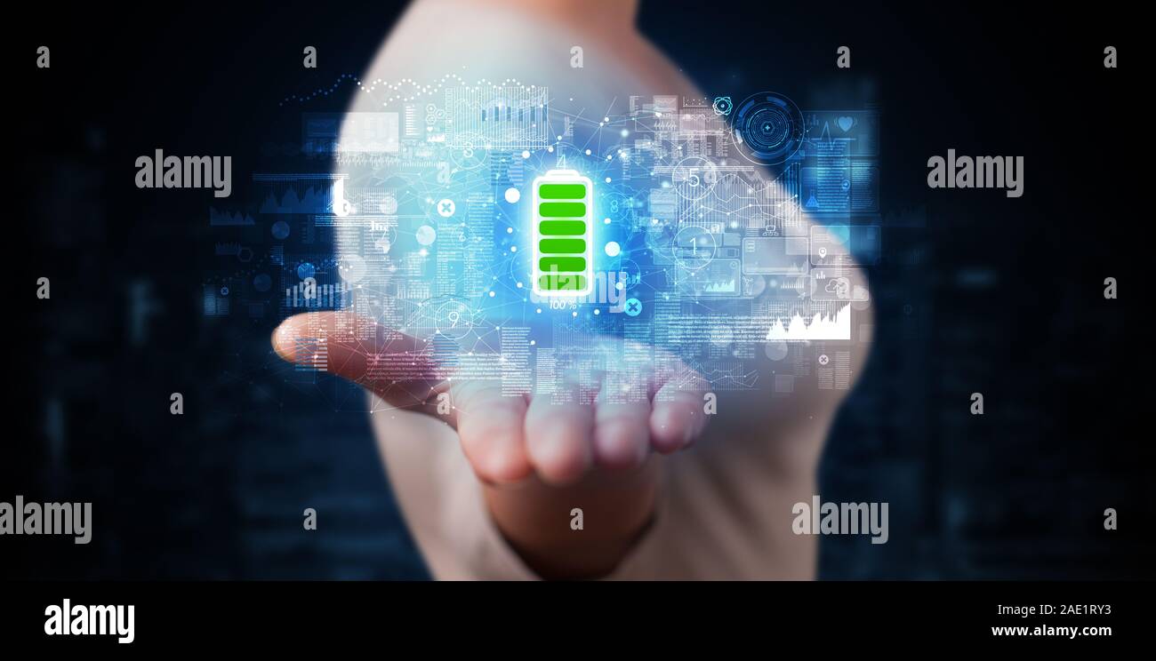 Elegant hand holding battery with full of energy Stock Photo - Alamy