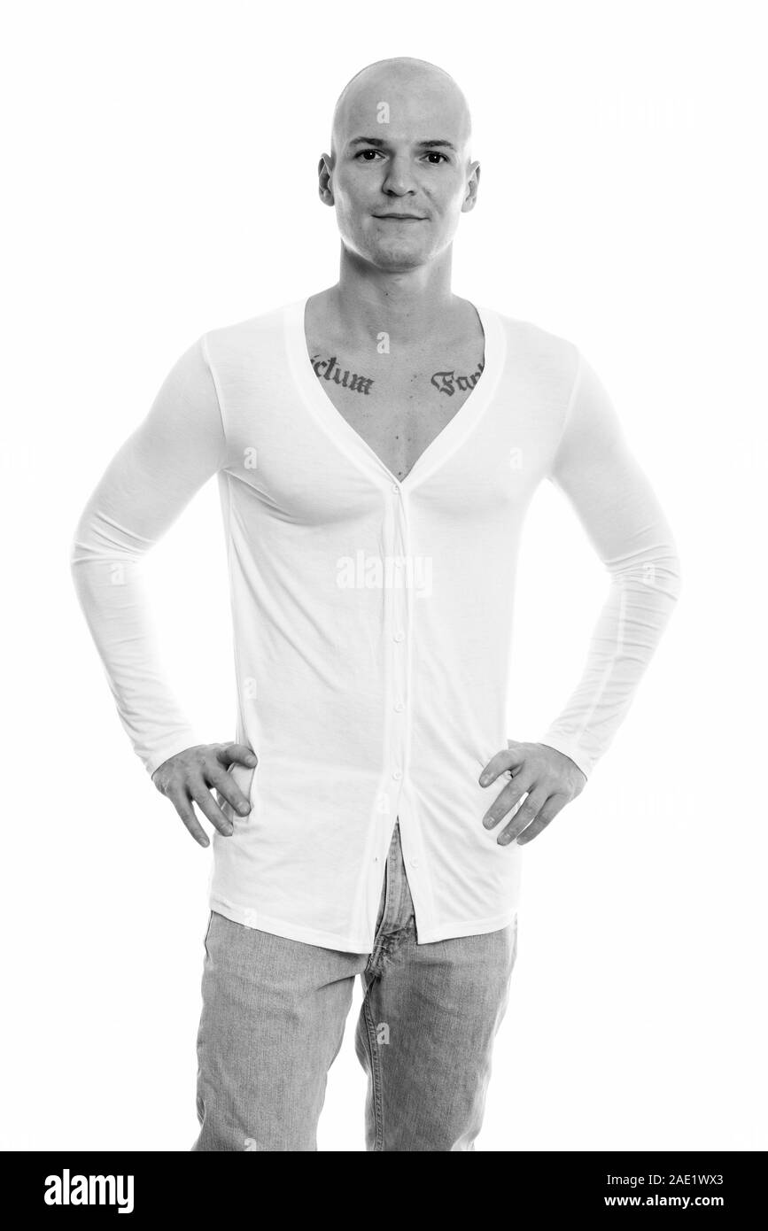 Studio shot of young handsome bald man standing while posing Stock ...