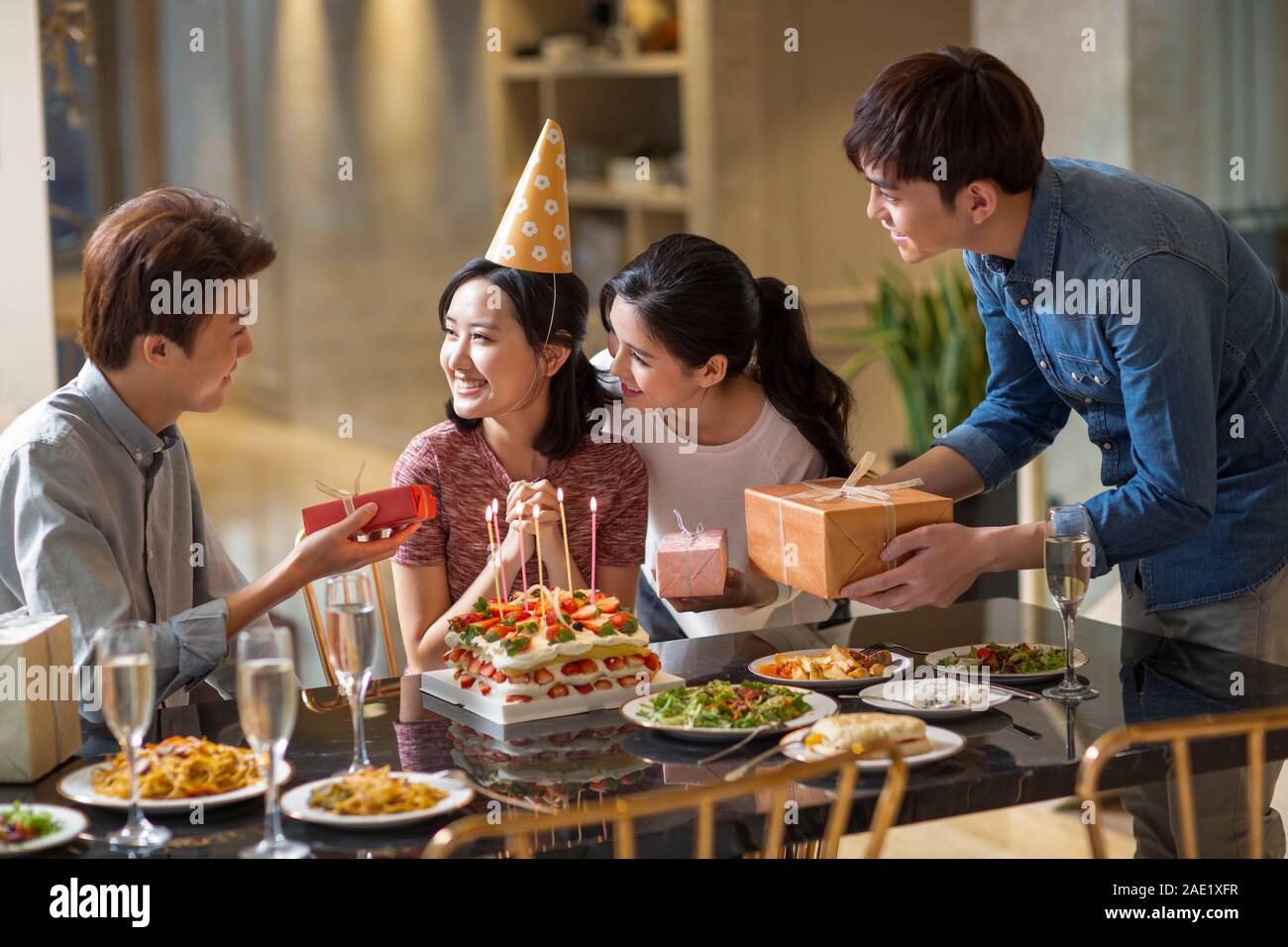 Young friends having birthday party at home Stock Photo - Alamy
