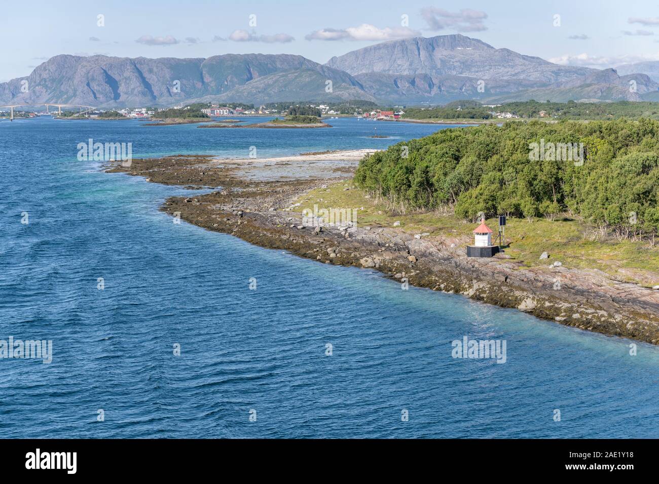 fjord landscape with light house and birch trees on low cliffs with ...