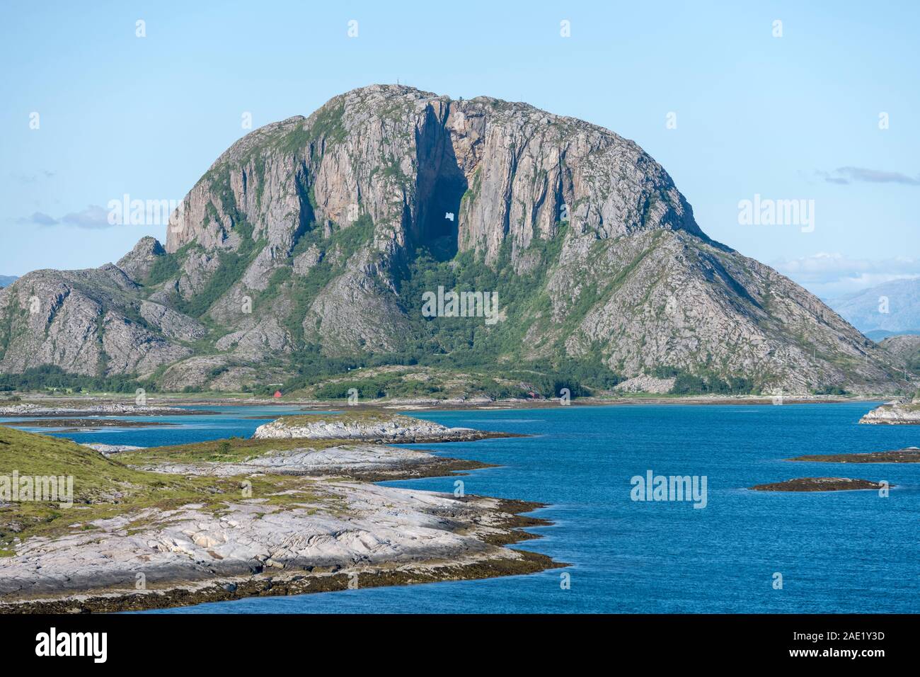 fjord landscape with steep rocky hill with hole in huge cavern and ...