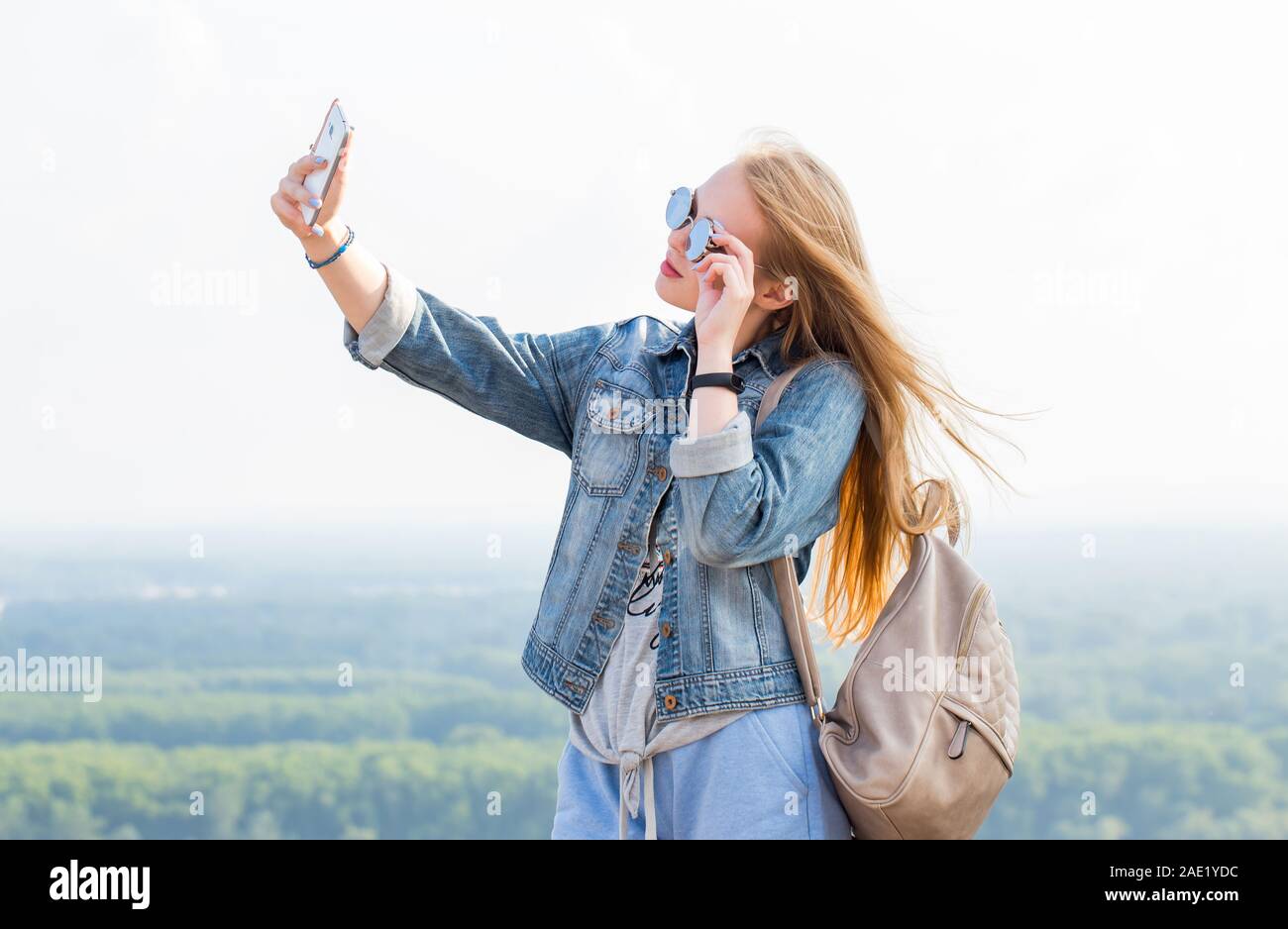 Beautiful Happy Blonde Girl Taking Selfies Outdoors In The Park