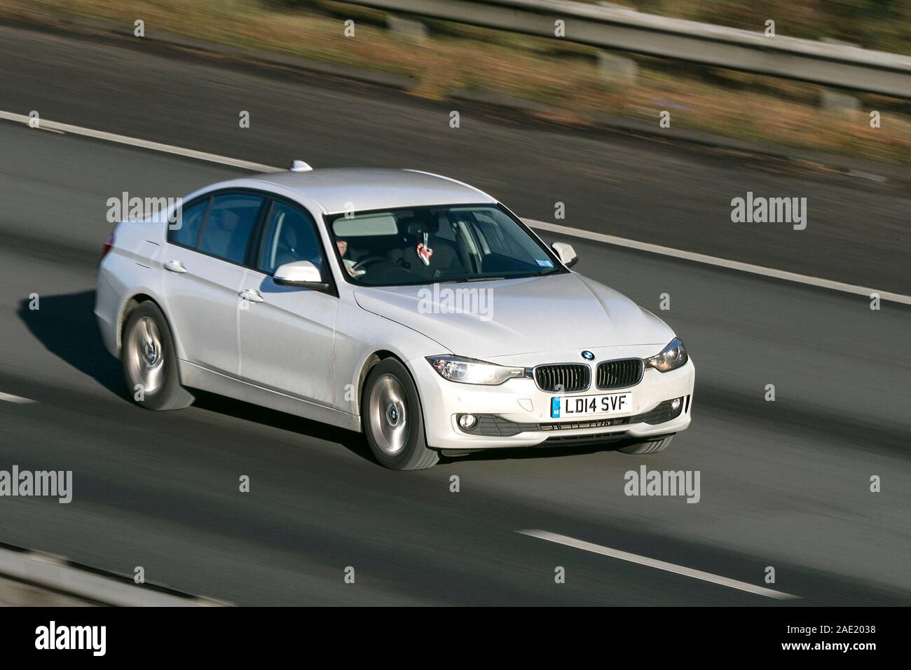 2014 BMW 316I SE Auto; Blurred moving car traveling at speed on the M61 ...