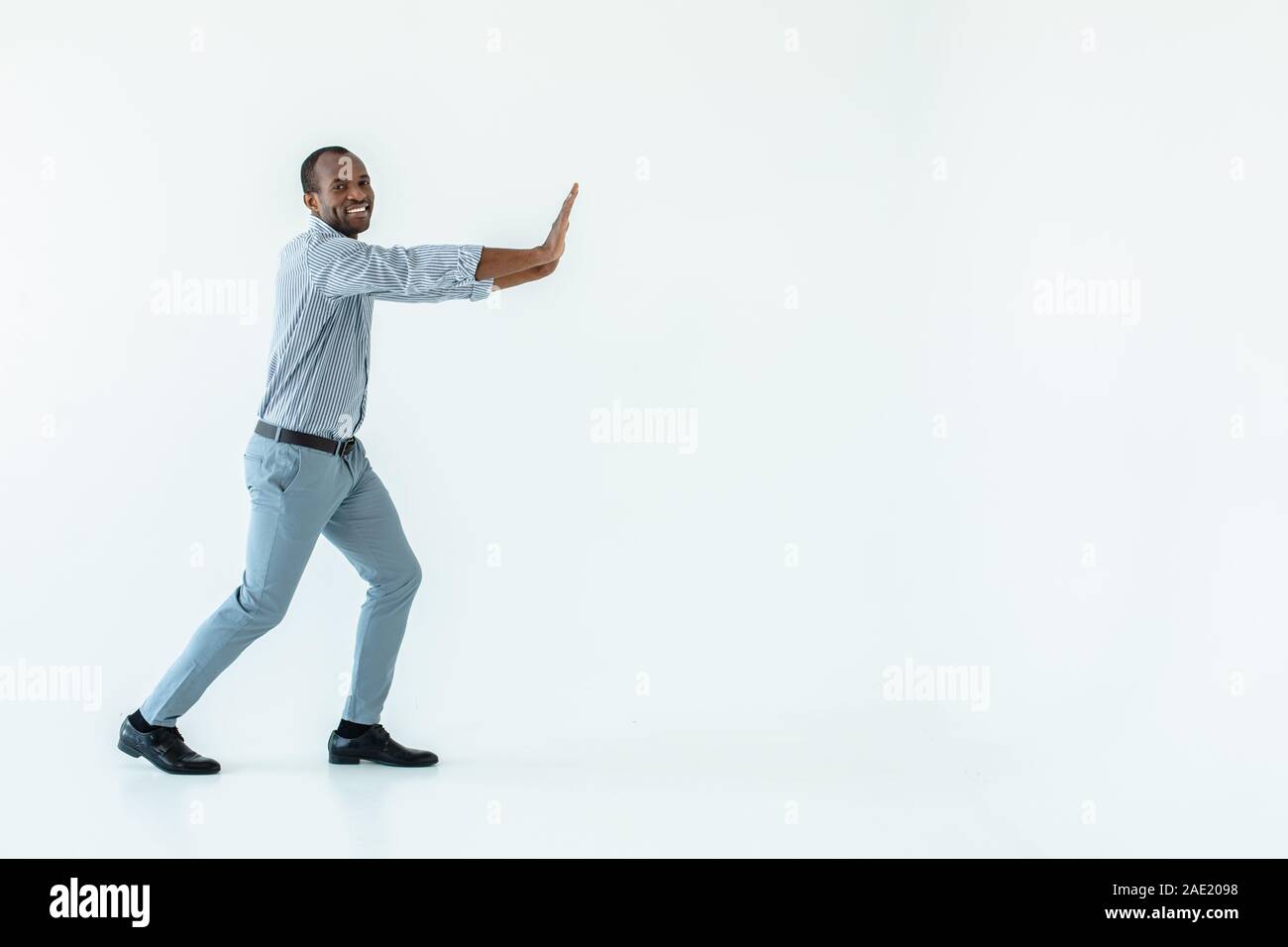 Positive afro american man pushing the block Stock Photo - Alamy
