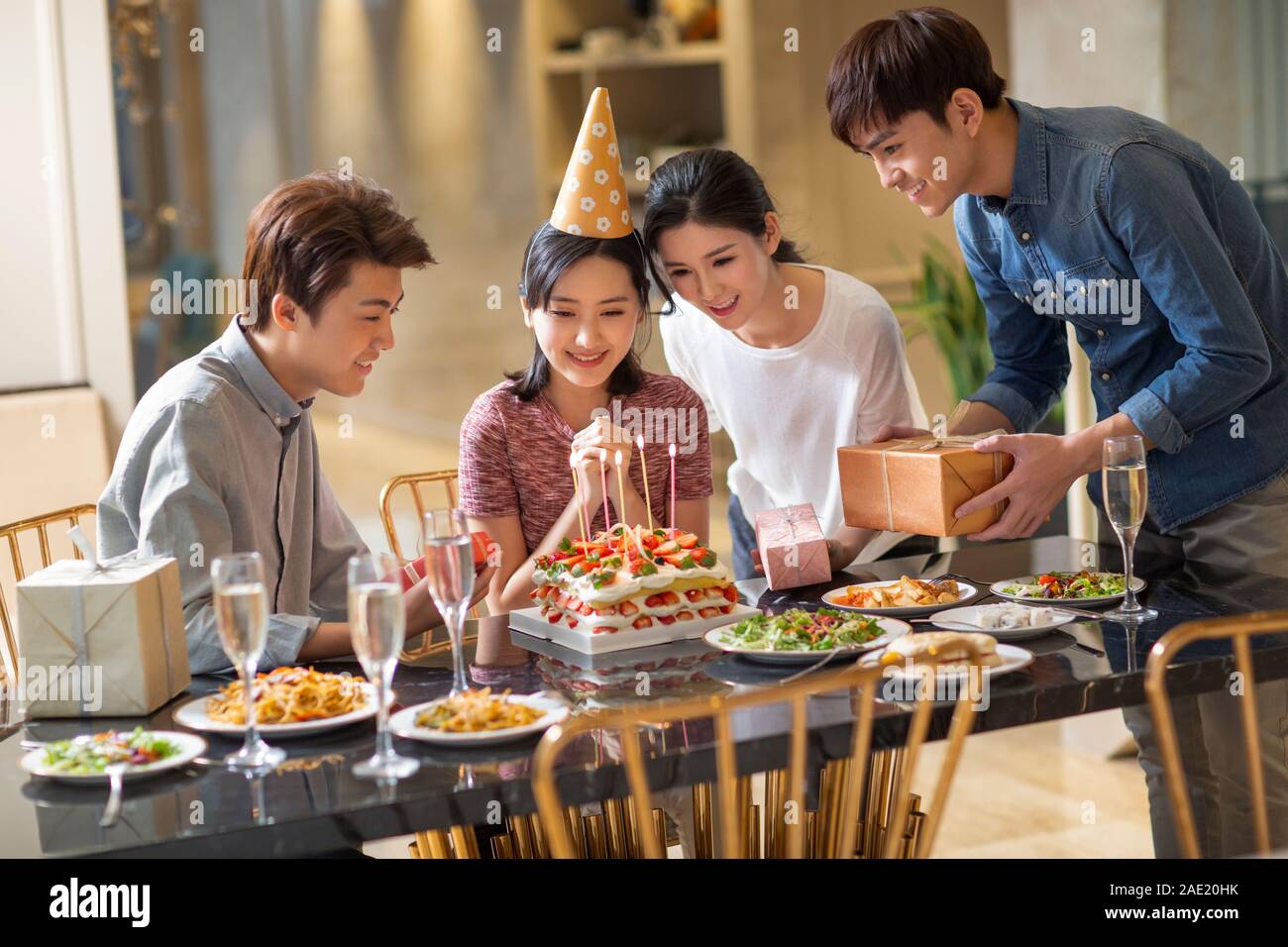 Young friends having birthday party at home Stock Photo - Alamy