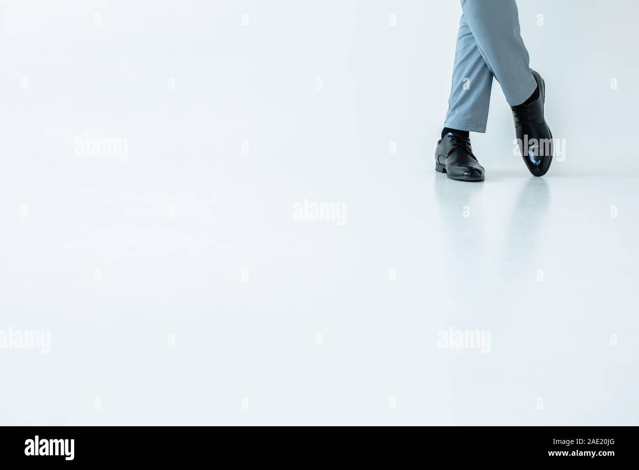Low angle of mans feet against white background Stock Photo - Alamy