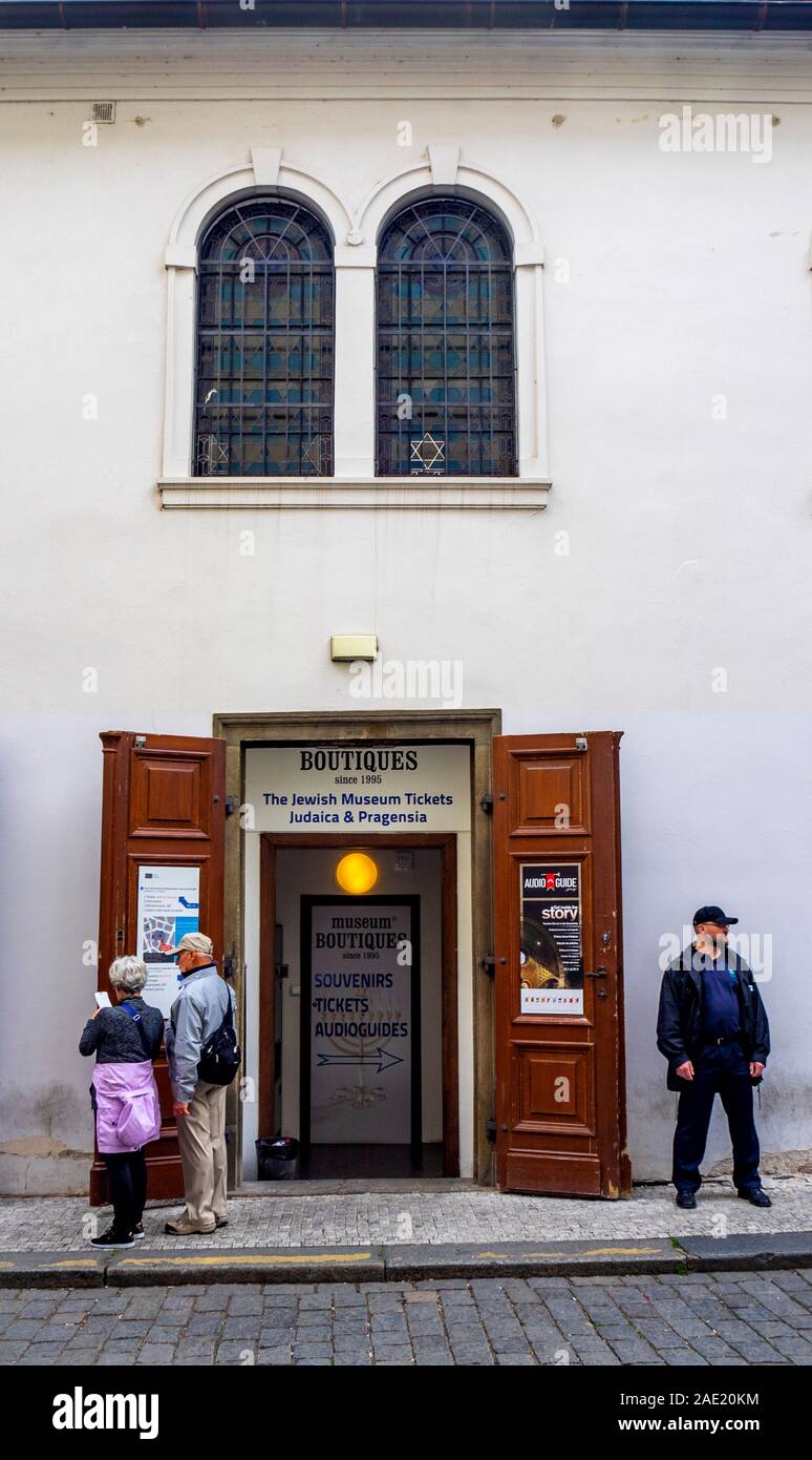 Two elderly tourists and a security guard outside entrance to Klausen ...