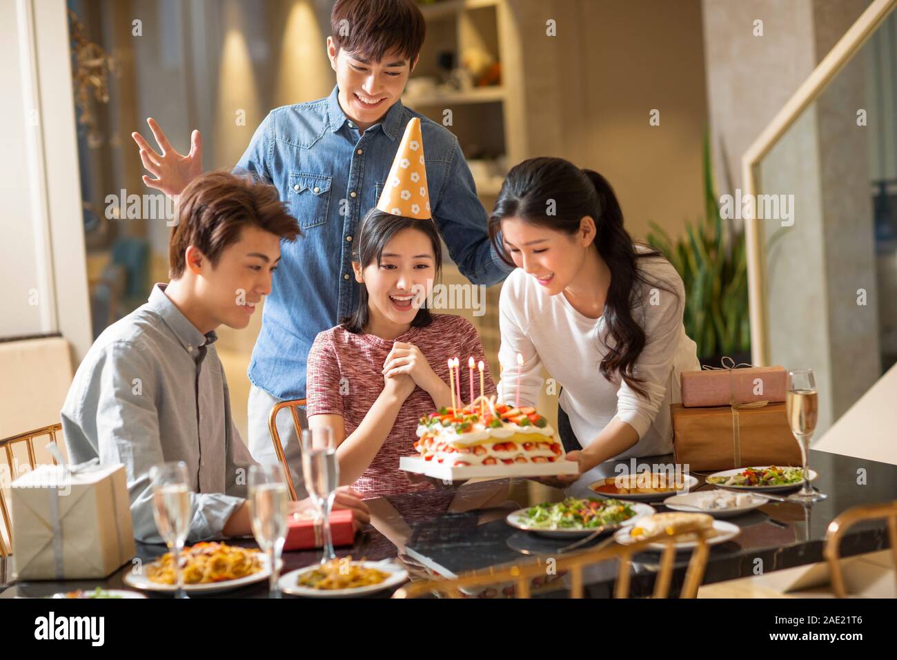 Young friends having birthday party at home Stock Photo - Alamy