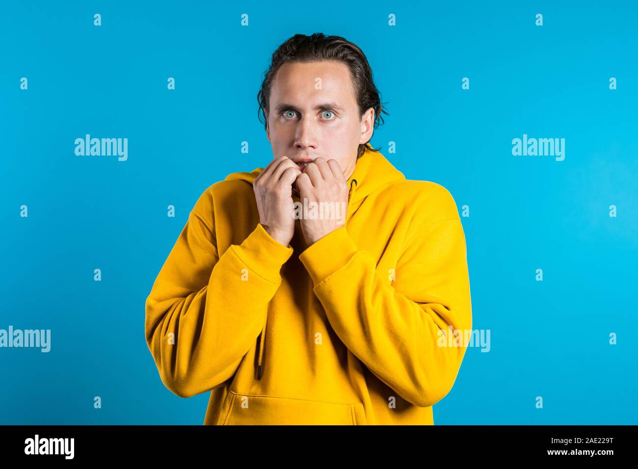 Frightened european man afraid of something and looks into camera with ...