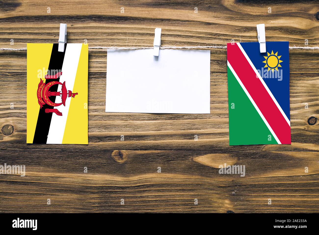 Hanging flags of Brunei and Namibia attached to rope with clothes pins ...
