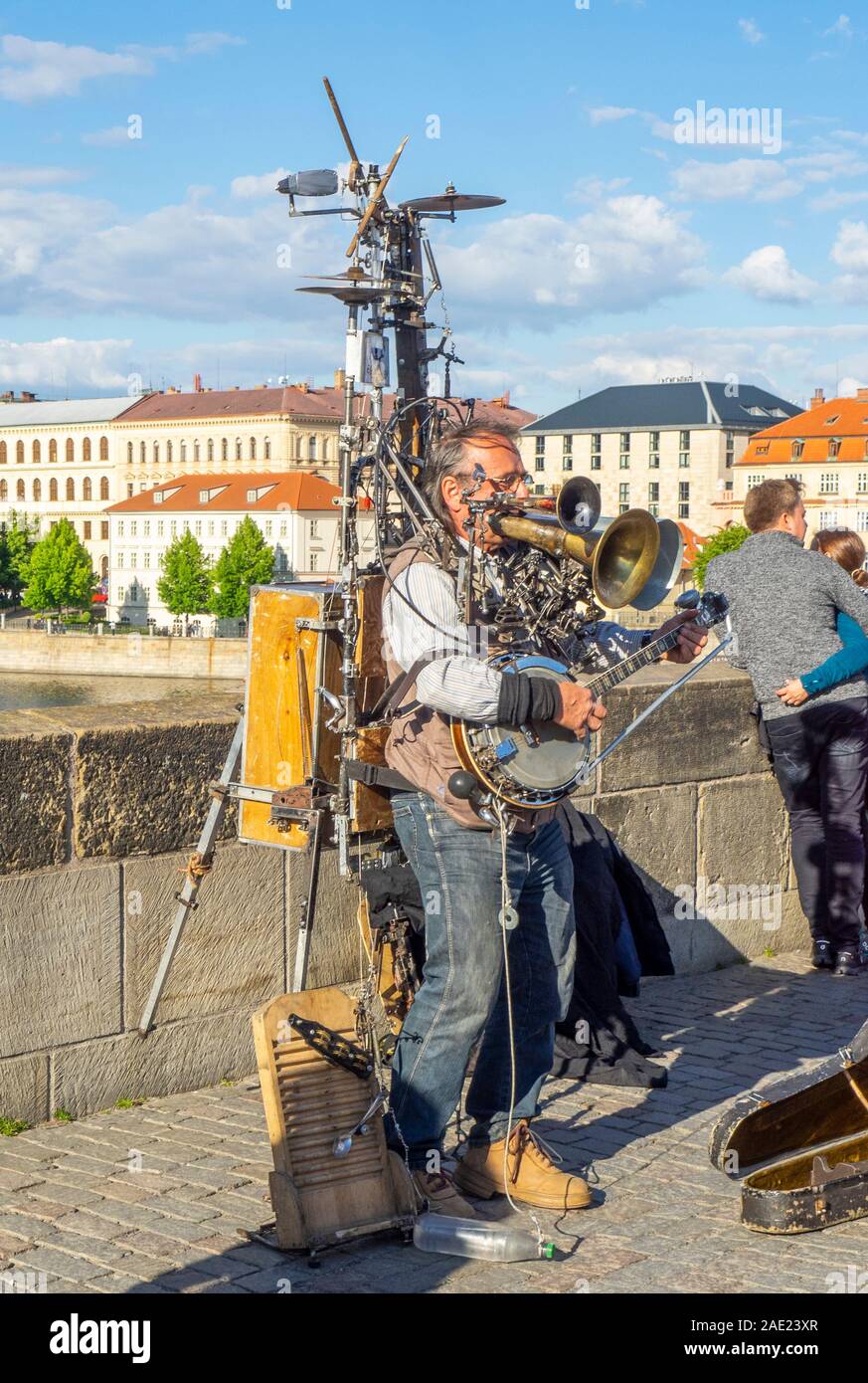 Busker playing many musical instruments on the Charles Bridge Prague ...