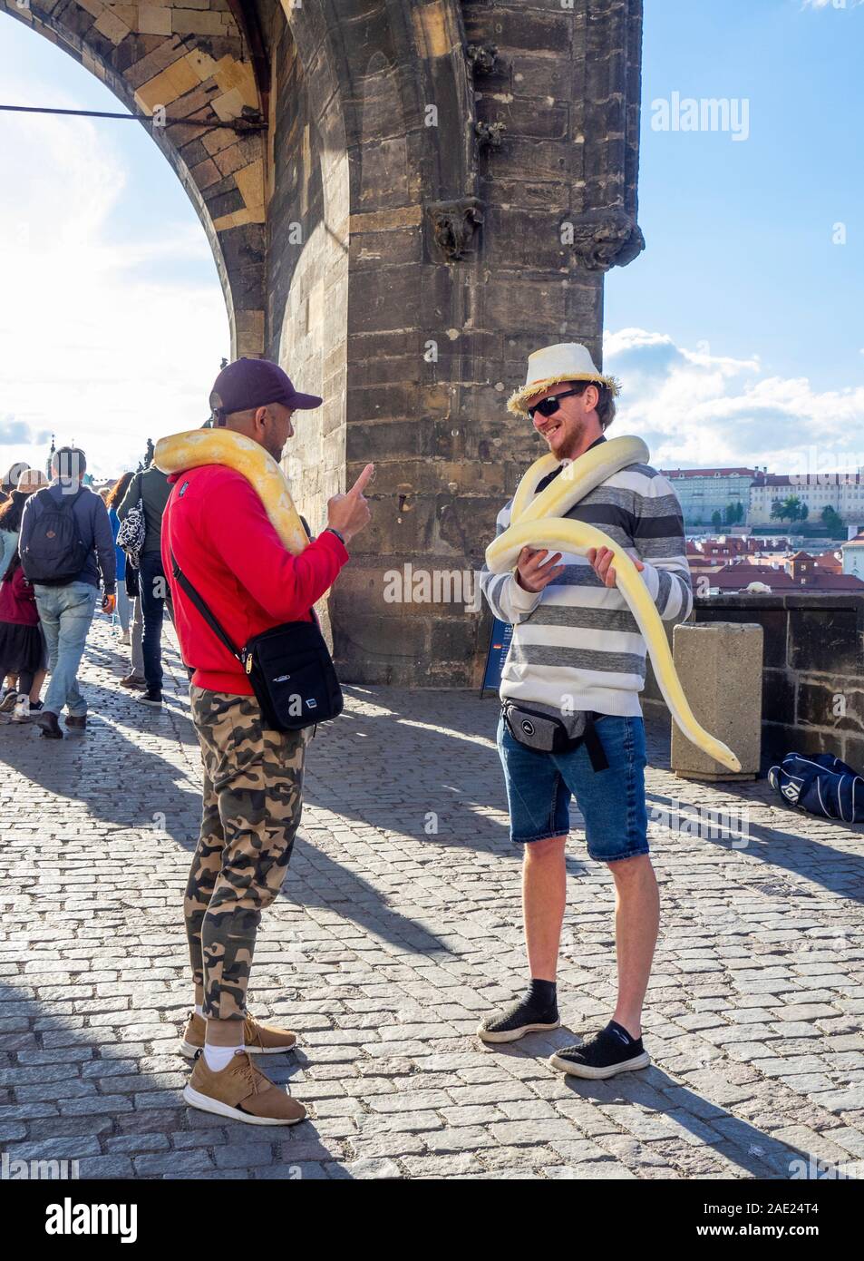 Charles Bridge two male touts with python snakes for tourists to take ...