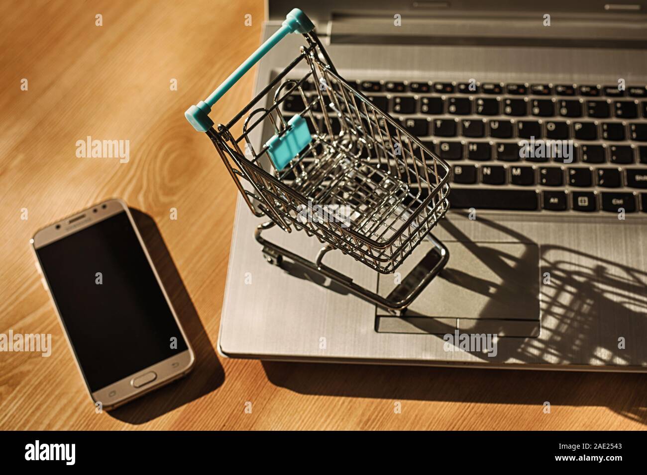 Shopping cart on laptop computer keyboard. Online shopping concept ...