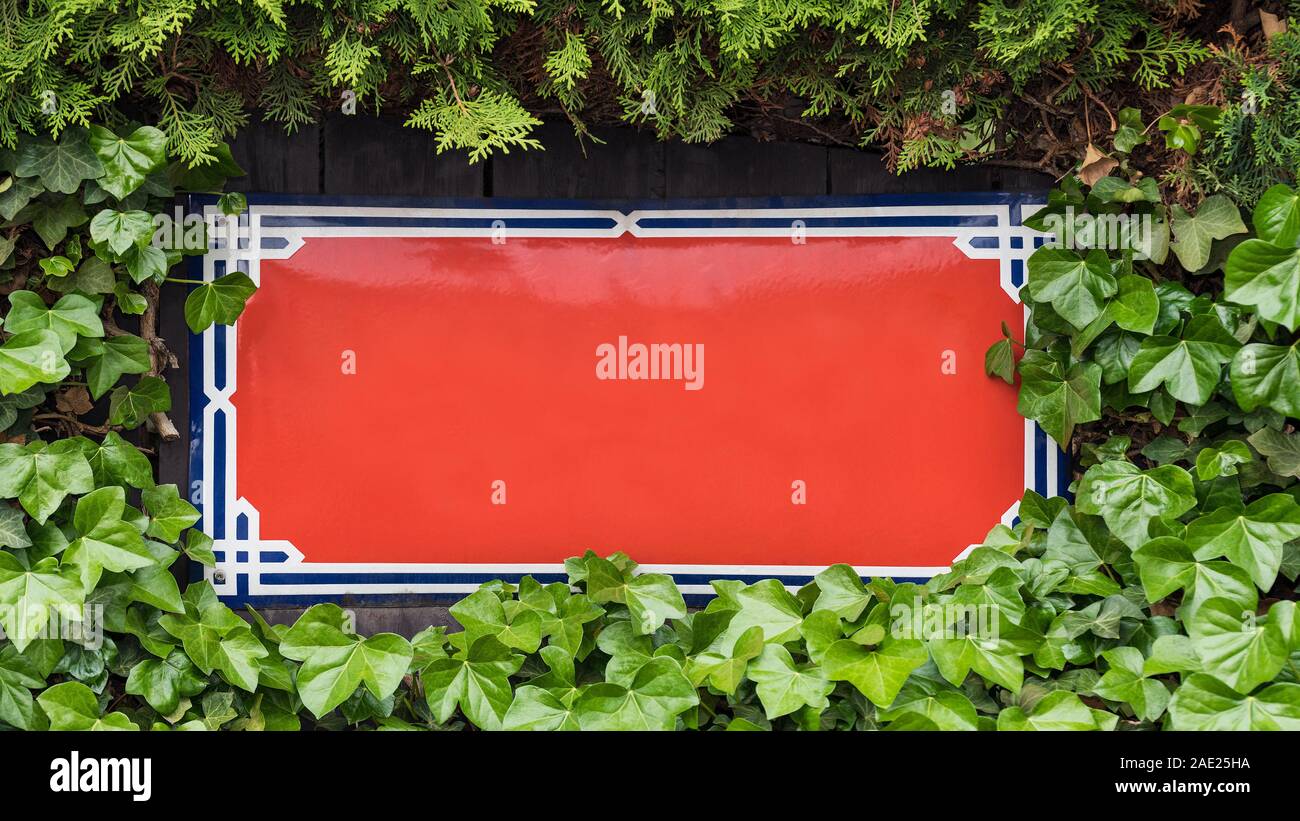 Red rectangular metal sign board. Ornate blank metallic nameplate ...