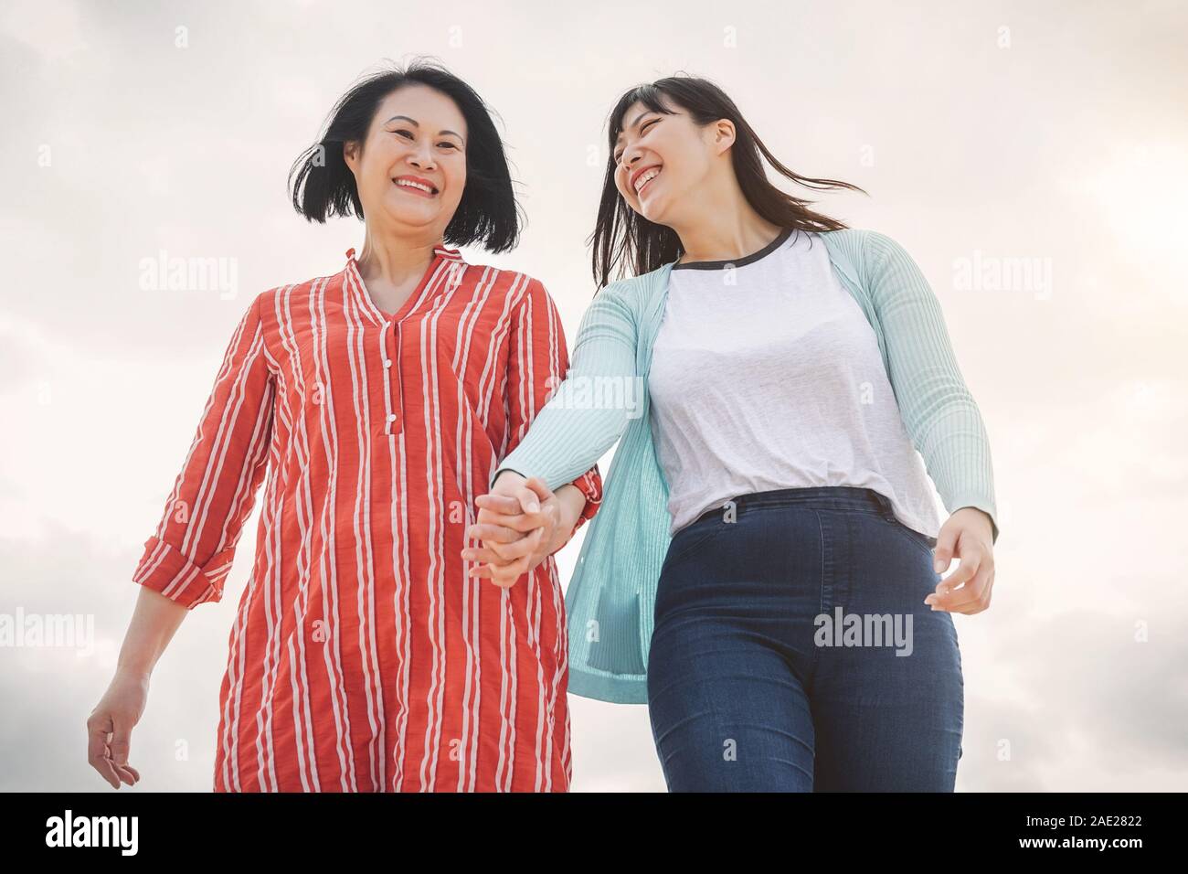 Happy Asian mother and daughter having fun outdoor - Chinese family ...