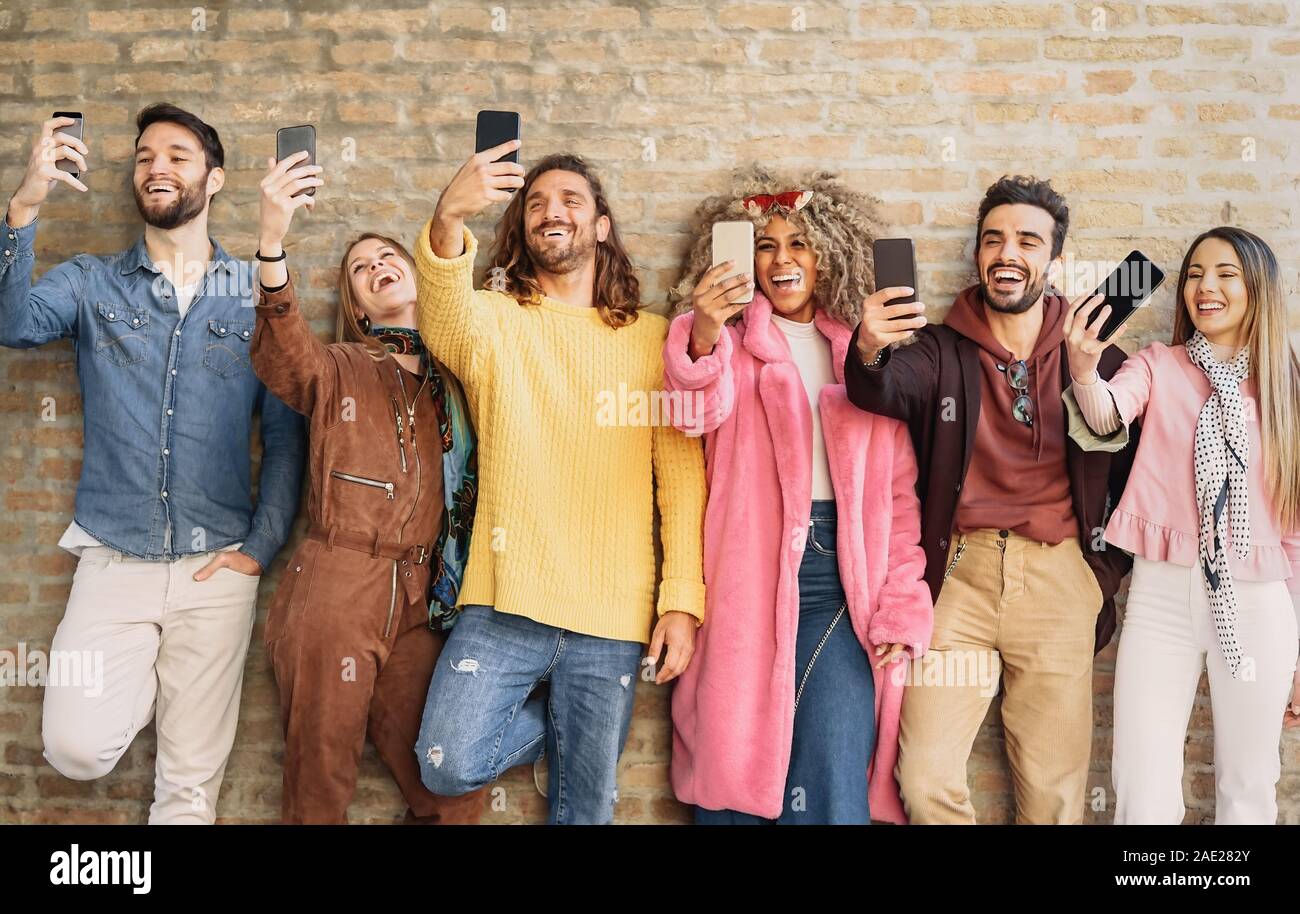Happy group friends taking selfie with cell phone outdoor - Young ...
