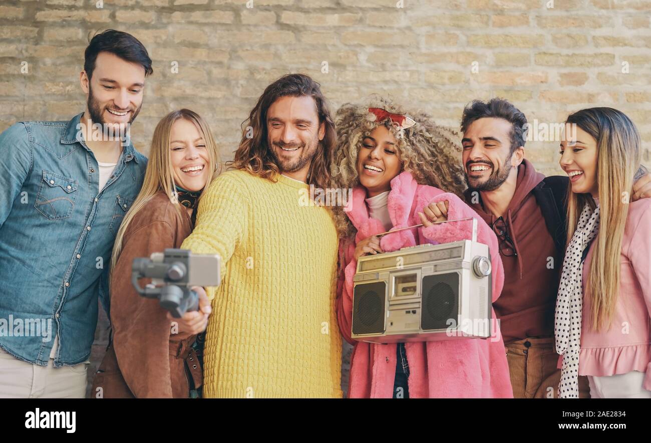 Happy friends taking video with gimbal mobile smartphone outdoor ...