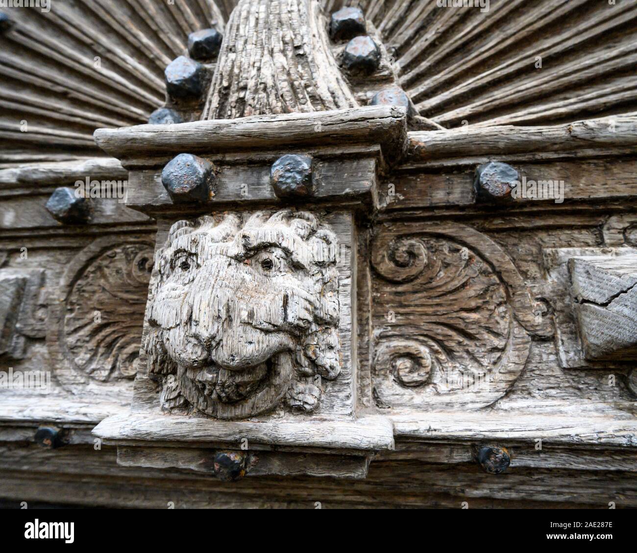 Carved lion detail of the studded oak door to the courtyard of the ...