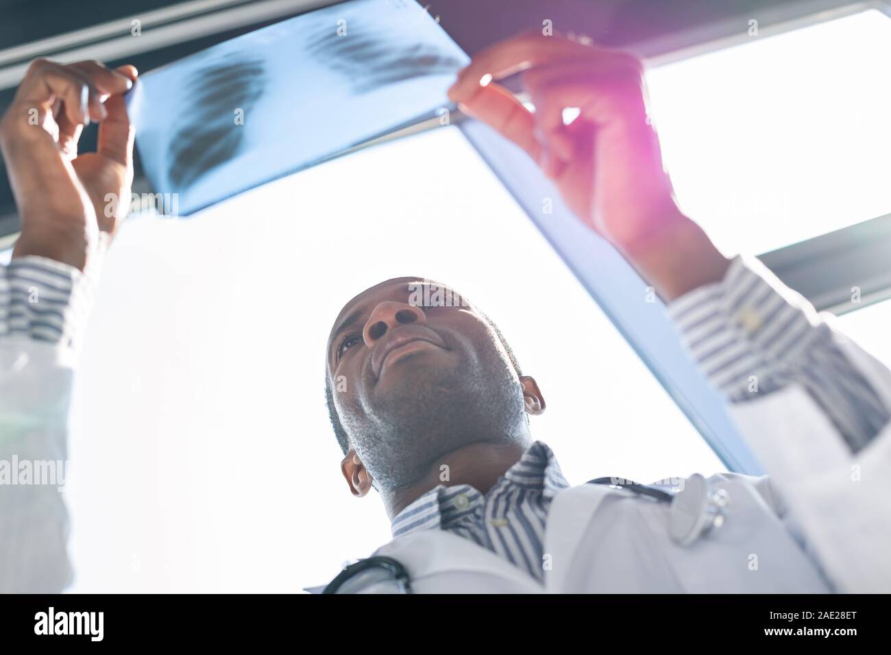 Focused photo on international student that doing task Stock Photo - Alamy