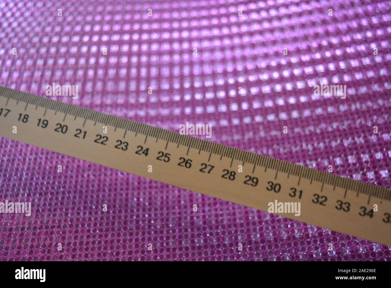 Light wooden mathematical ruler on a pink reflective background Stock ...