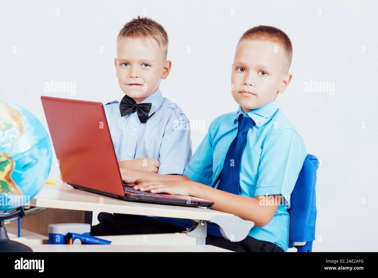 study on the computer two boys at school Stock Photo - Alamy