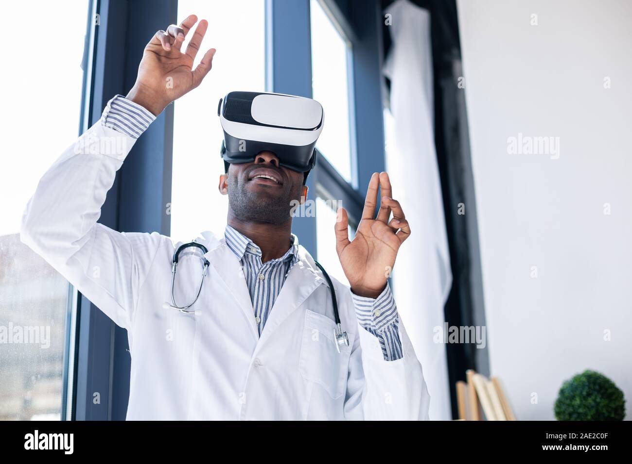Handsome male person raising both arms Stock Photo - Alamy
